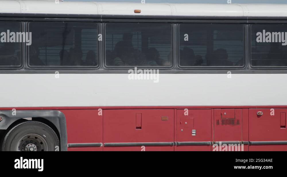 Recently detained migrants sit on a US Border Patrol bus along the ...
