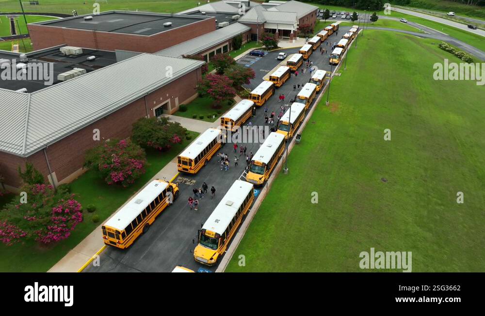 Line of school bus. Students at school building in USA. Transportation ...