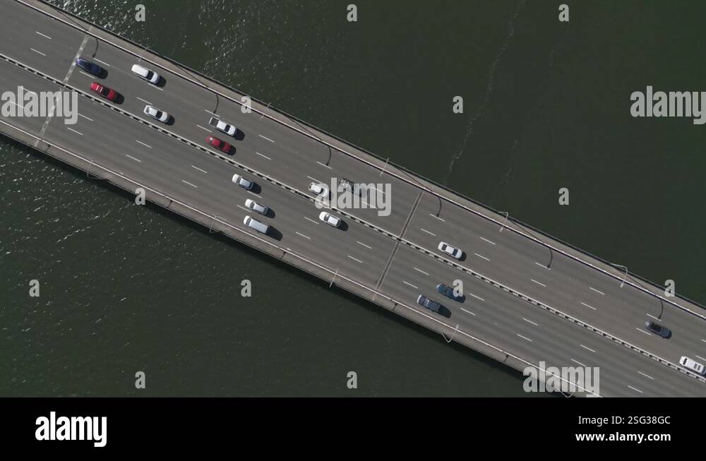 Aerial zoom in busy road bridge highway directly over the Captain Cook ...
