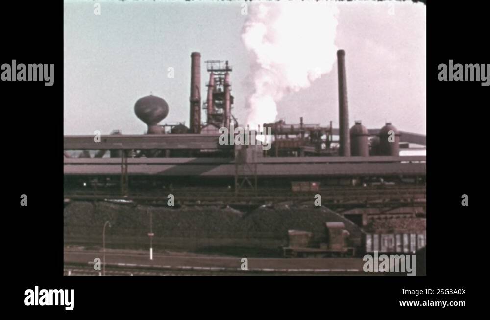 1960s: Workers outside steel factory. Interior mill with molten metal ...