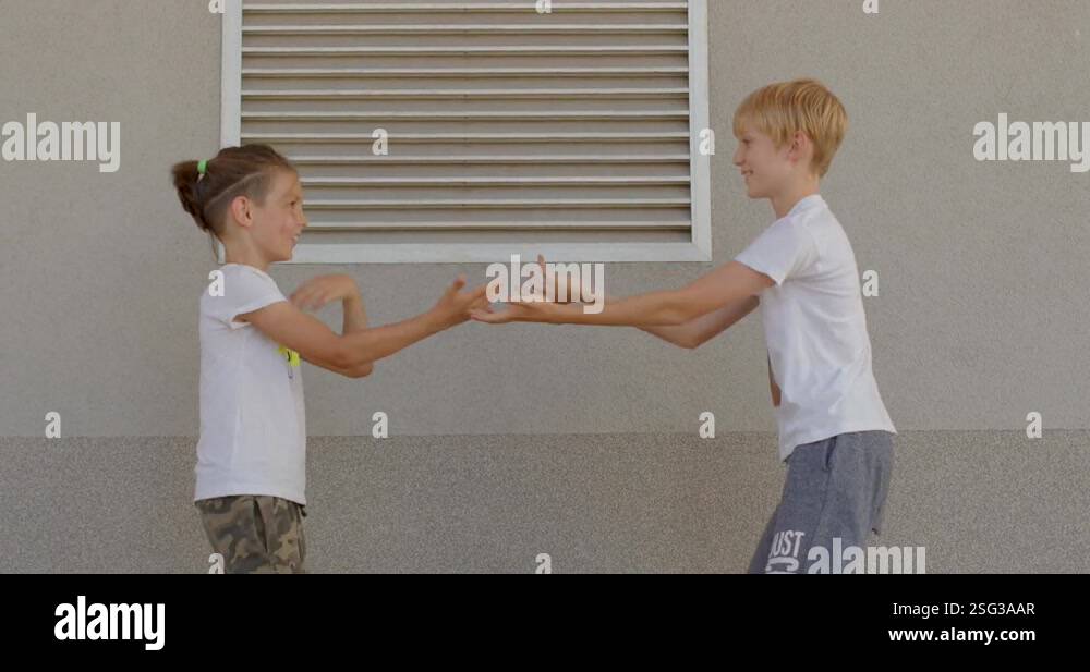 Cheerful boys dance near ventilation grate make movements their hands and body Stock Video ...