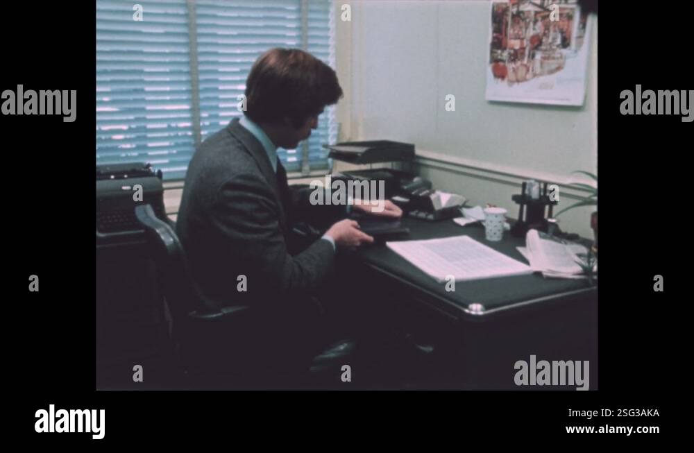 1970s: man works at office desk in 1970s. Man with 1970s moustache and ...