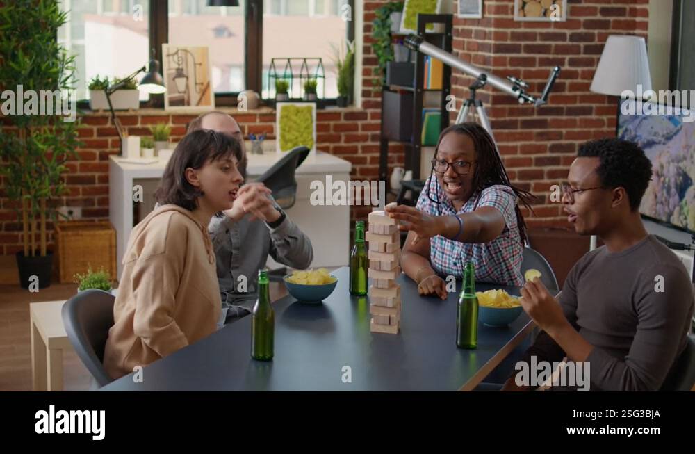 Men and women laughing while they play society game Stock Video Footage ...