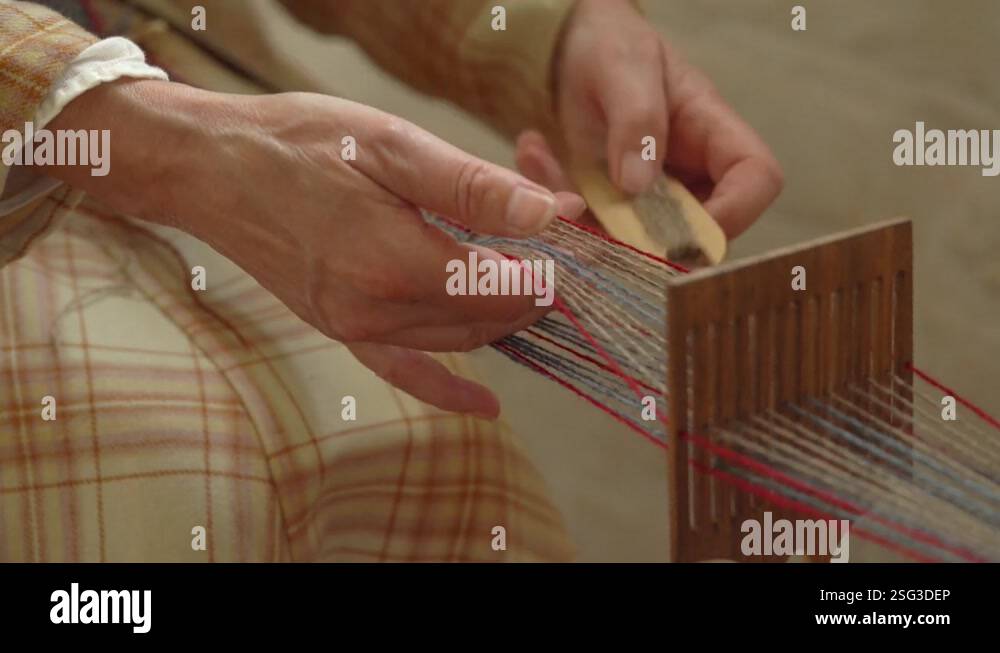Old Scandinavian Woman Weaving Narrow Band With Yarn On Loom. - close ...