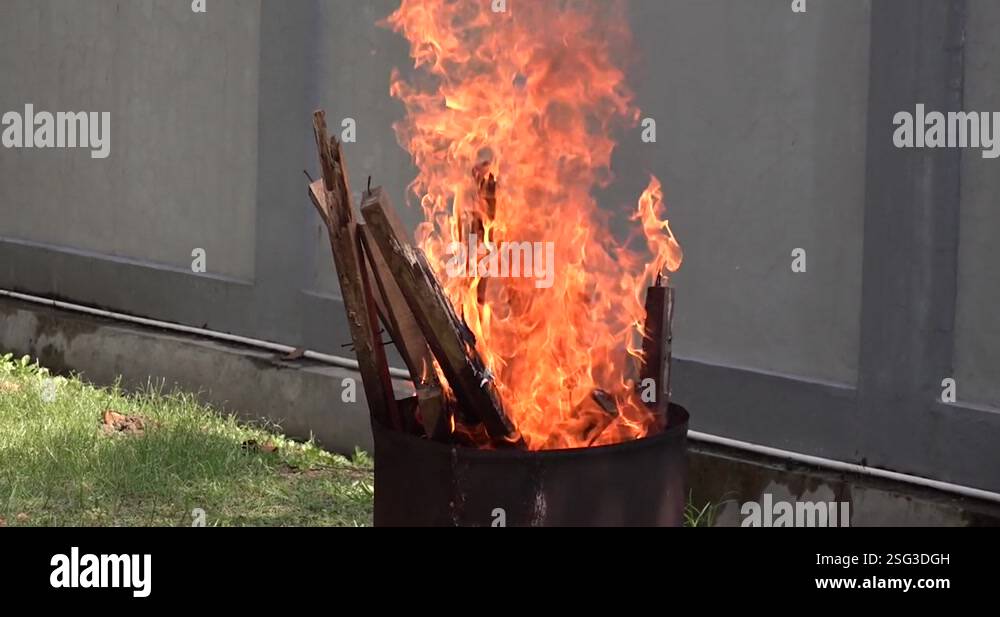 Burning orange flame in barrel outdoor. Made barrel, burning inside ...