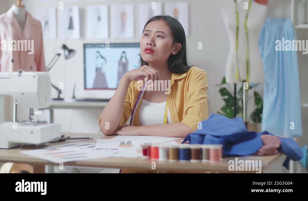 Asian Female Designer With Sewing Machine Thinking While Designing ...