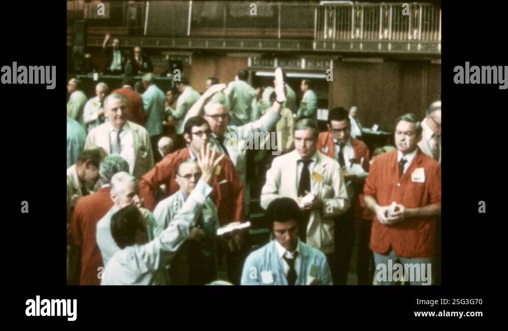1970s: Traders on stock market floor, zoom out. Man pouring grain into ...
