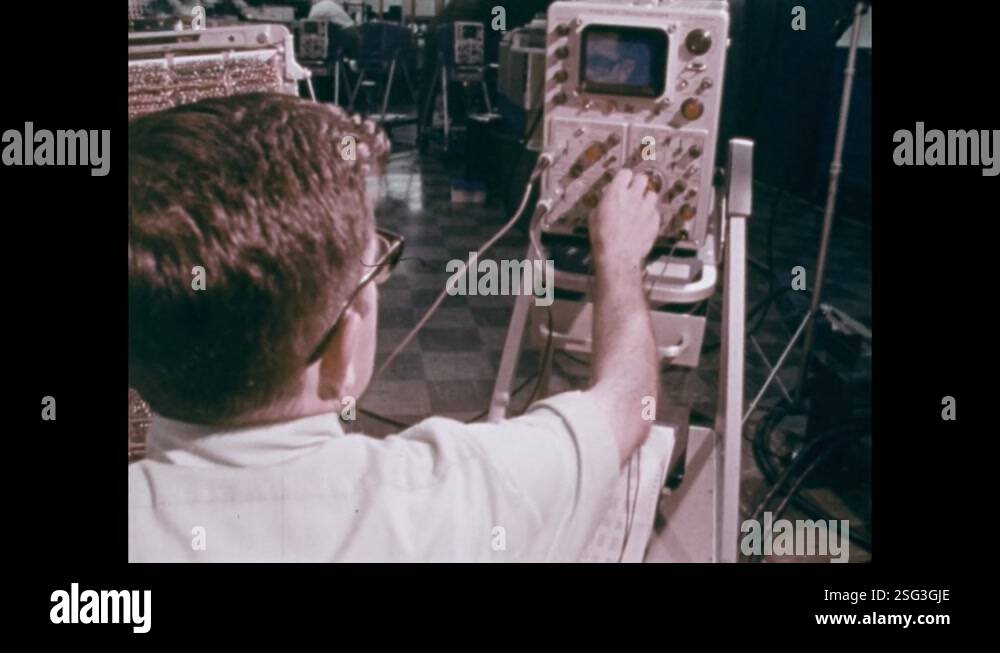 1970s: Man flips through electronics manual, turns dials on ...