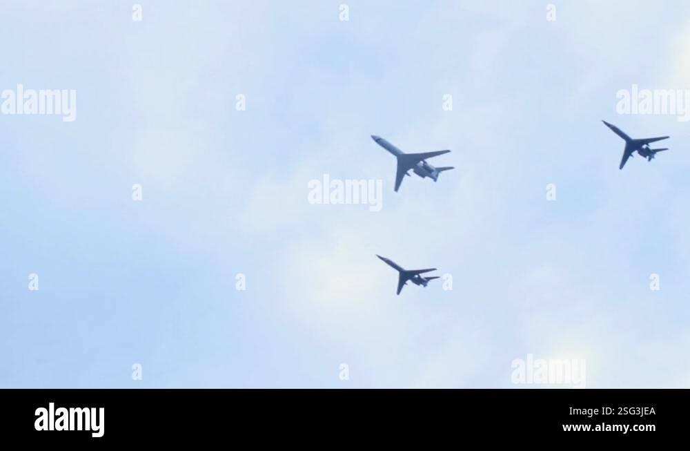 Spectators take pictures of military aircraft flying over in an even ...