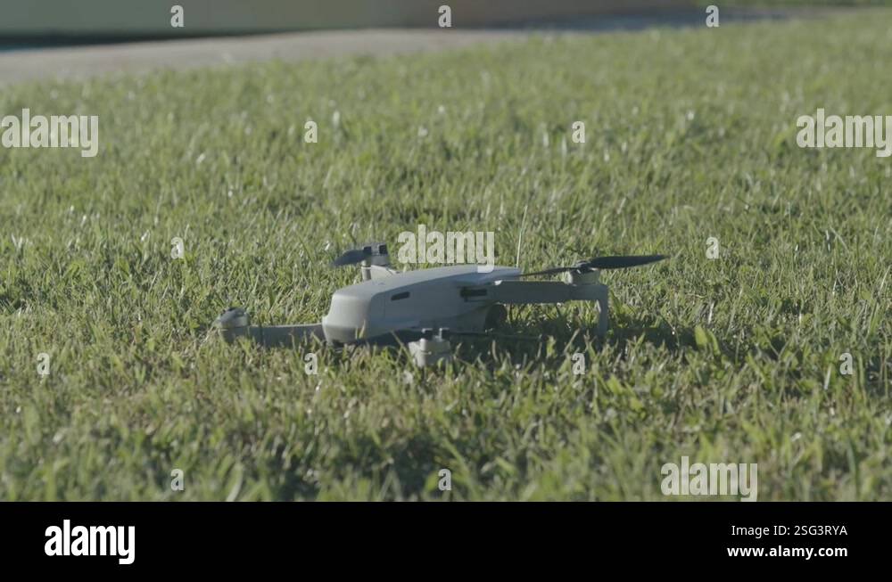 A drone takes off in slow motion, starts from the green lawn and rises ...