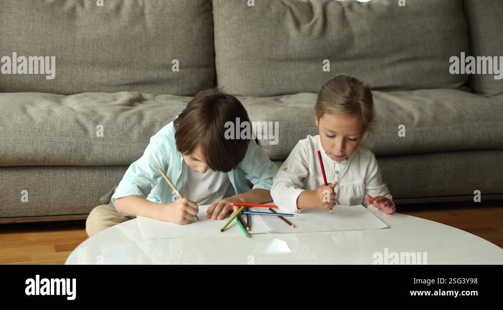 Two focused cute sibling children drawing in album papers Stock Video ...