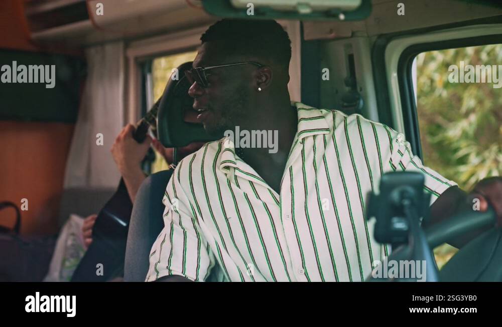 Dark-skinned young man driver close up. Multi-ethnic group of close ...