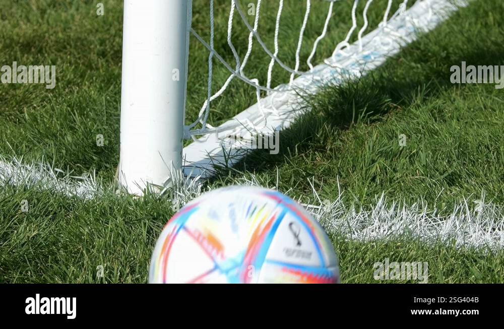 Slow-motion of a football getting inside of a goal and a keeper trying ...