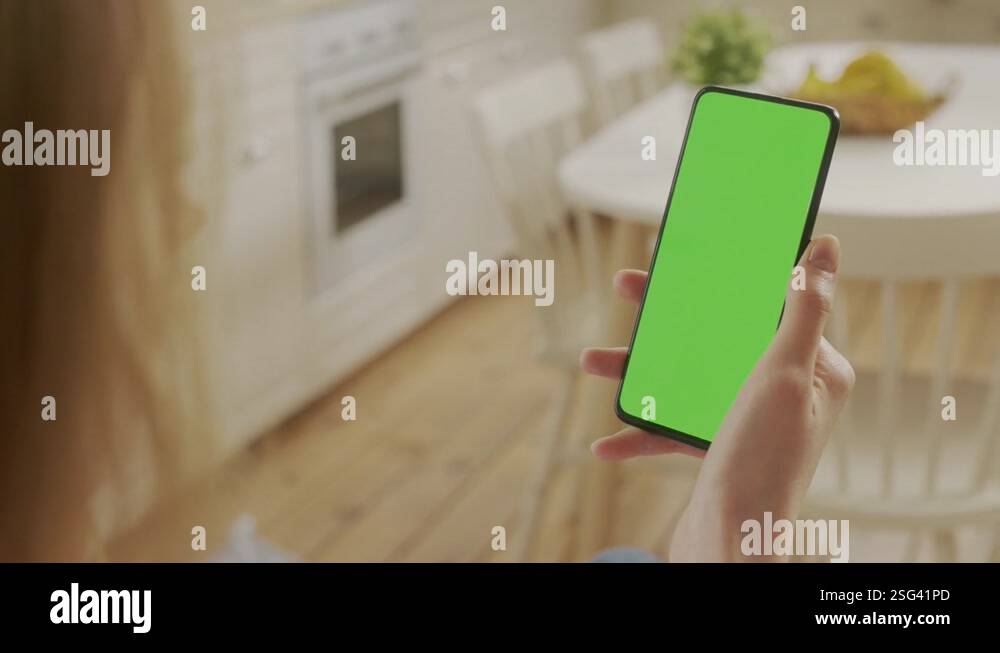 Handheld Camera: Back View of Blond Woman Holding Chroma Key Green ...