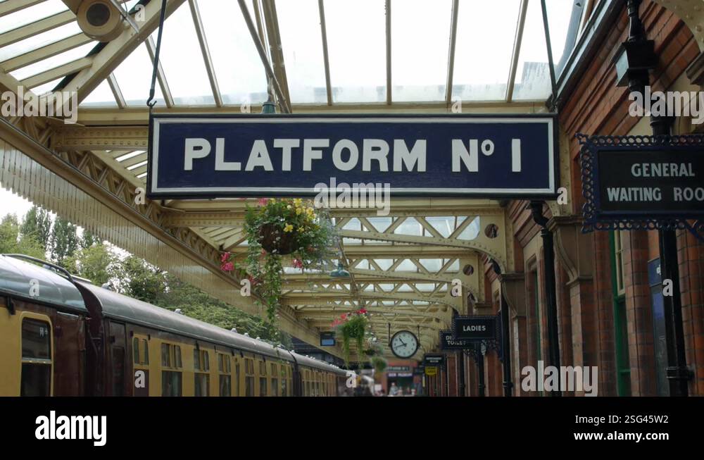 A vintage old platform one sign at a steam engine train railway station ...