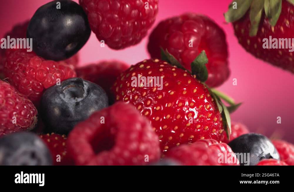 Ripe juicy Strawberry Blueberry Raspberry rolling above many mixed ...