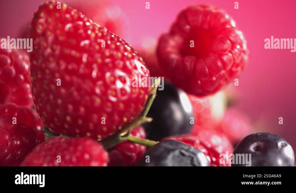 Ripe juicy Strawberry Blueberry Raspberry rolling above many mixed ...
