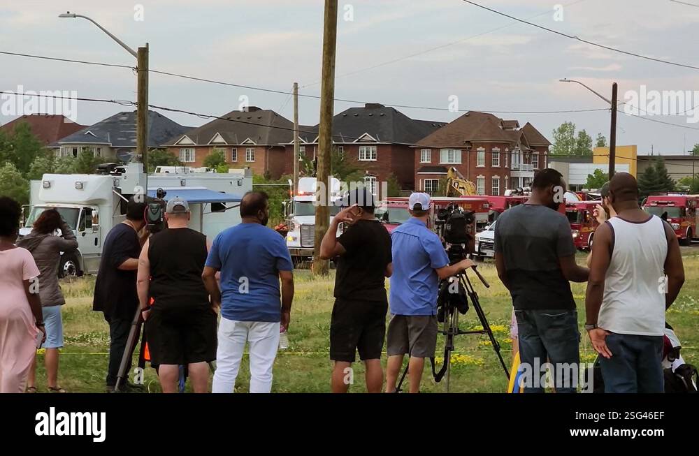 Onlookers gathers anxiously hoping for good news after the construction ...