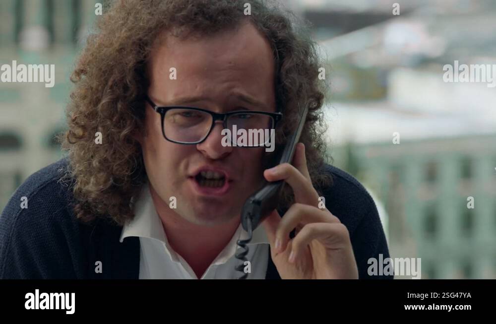 ZOOM OUT Crazy nerdy looking manager screaming into the phone during ...