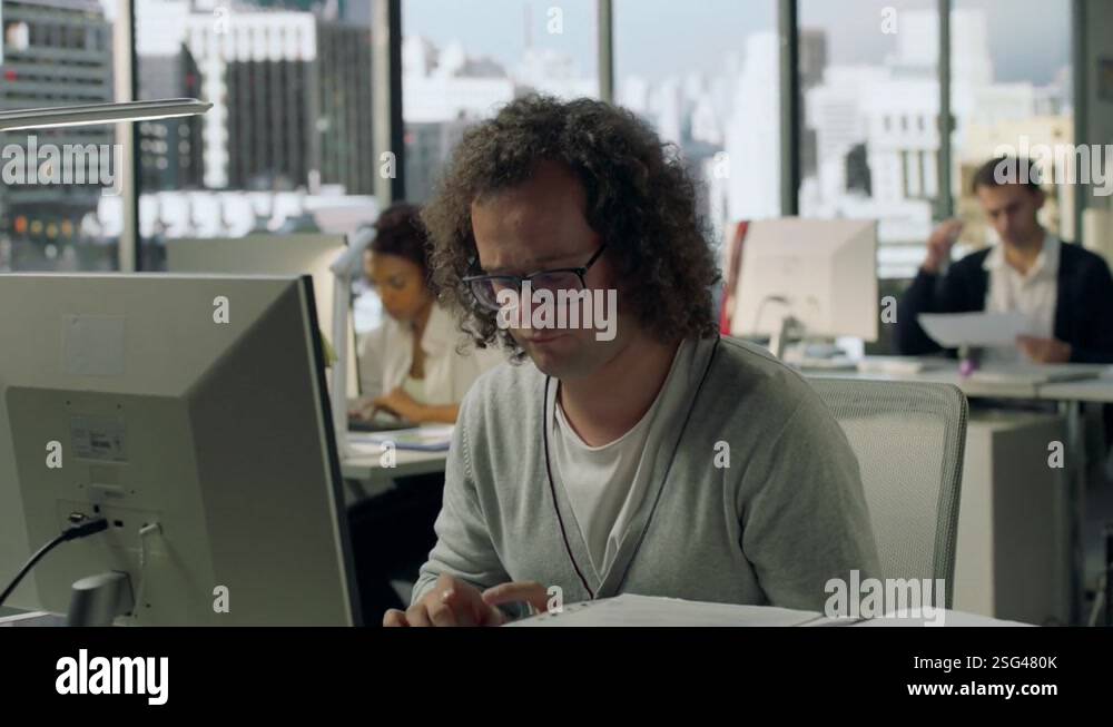 Portrait of nerdy office worker Caucasian male concentrated on a given ...