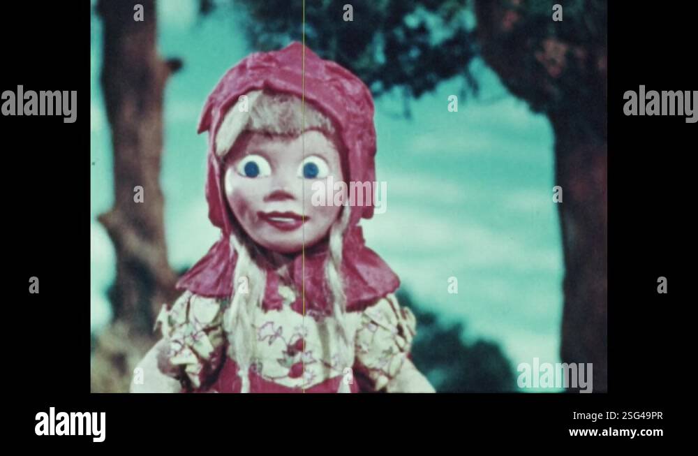 1940s: Stop-motion puppet animation- Little girl in red cape walks by a ...
