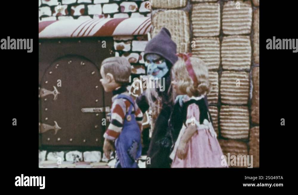 1950s: Stop-motion puppet animation- Boy and girl sit at table and ...