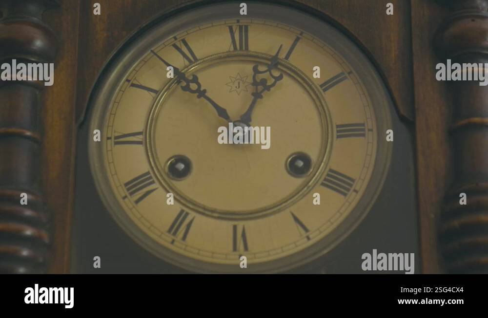 Beautiful and antique hanging pendulum clock, detail of Roman numerals ...