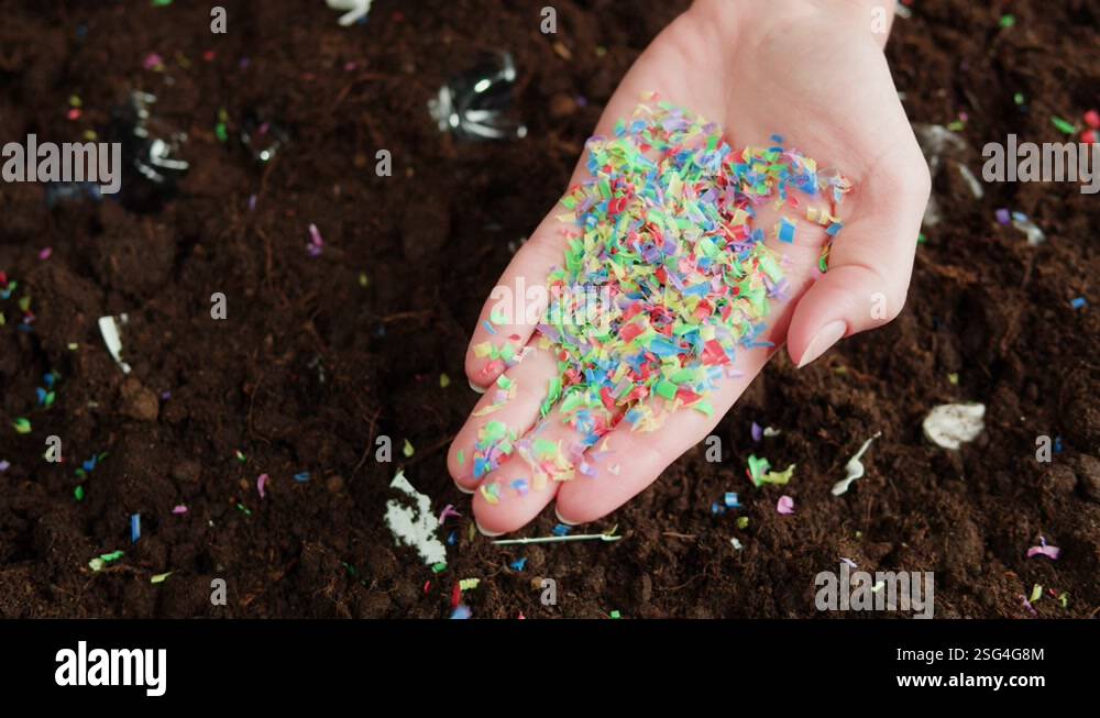 Microplastic earth pollution, plastic particles in soil close-up ...