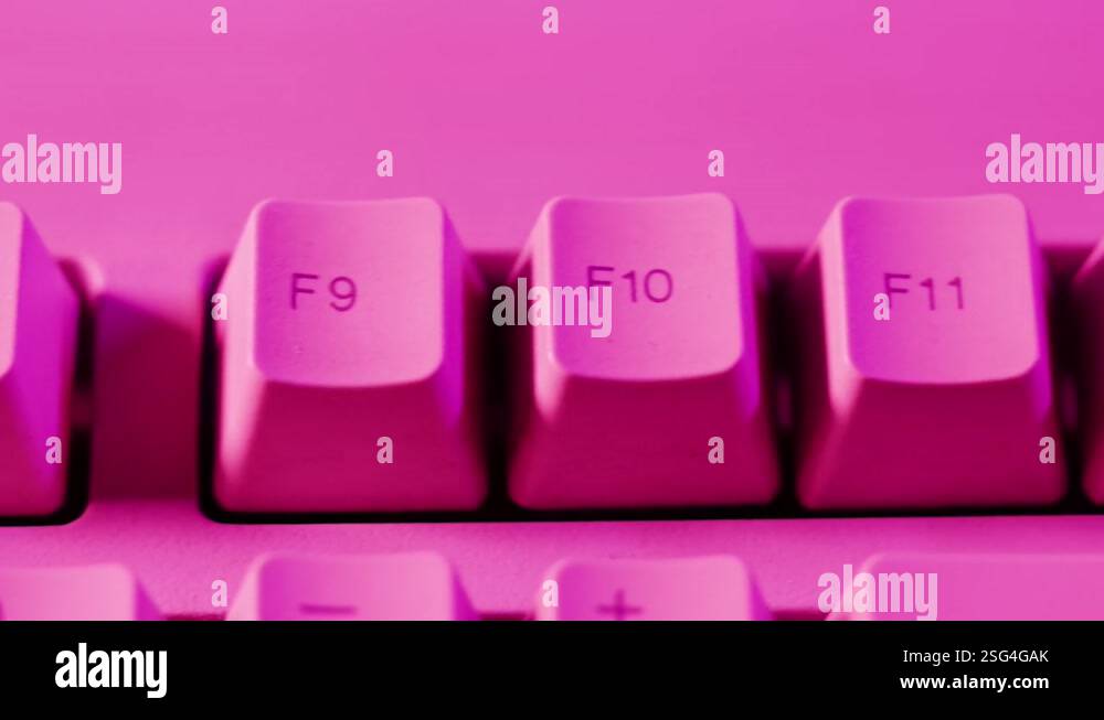 Old retro keyboard close-up. Computer buttons in neon pink light top ...