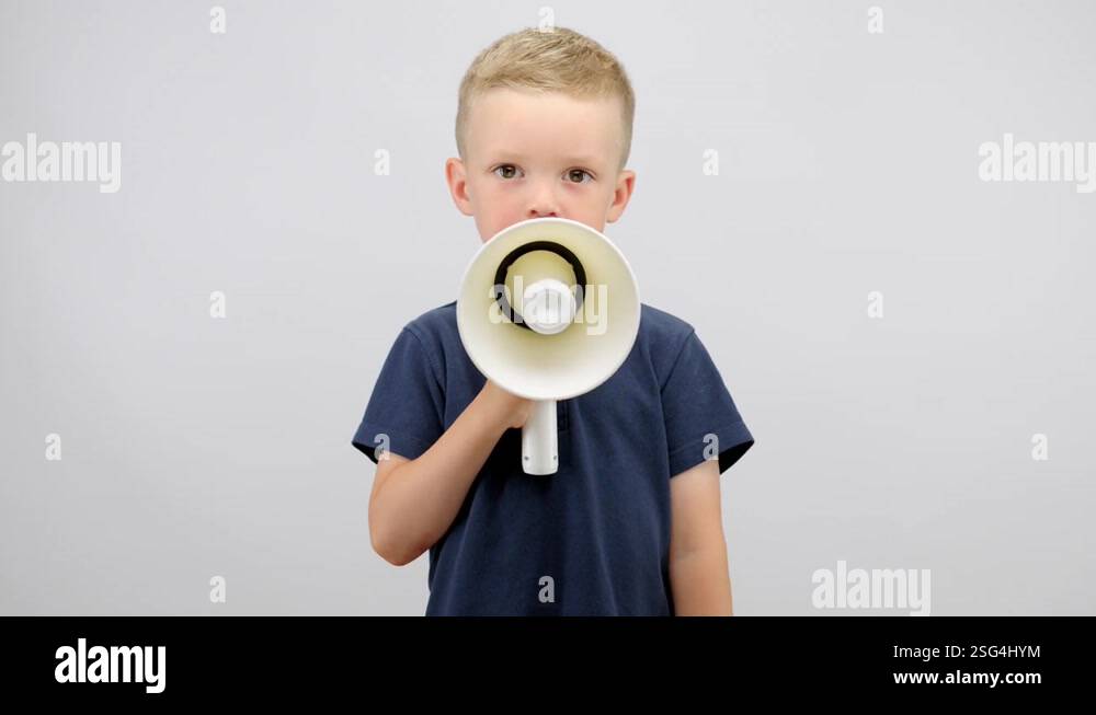 Cute blond kid boy is speaking loudspeaker his speech on white ...