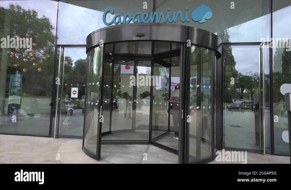 Employee entering through the revolving door of Capgemini's Building ...