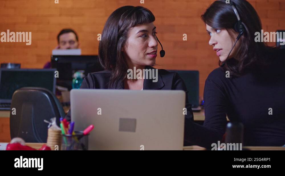 Female employee speaking with colleague at call center giving feedback. Two w Stock Video ...