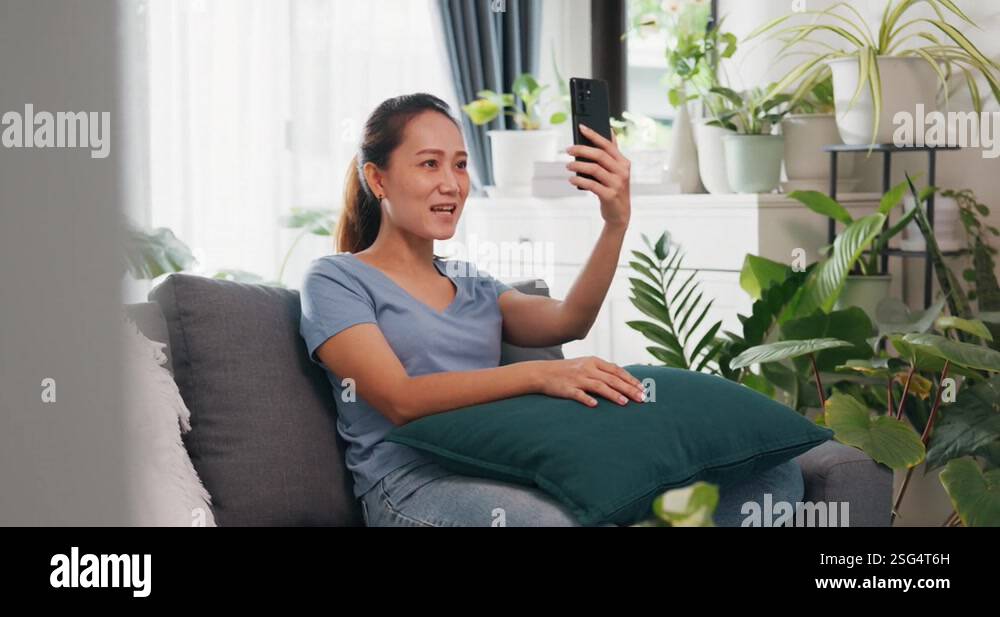 Asian woman use smartphone raise hand video call to family Stock Video ...