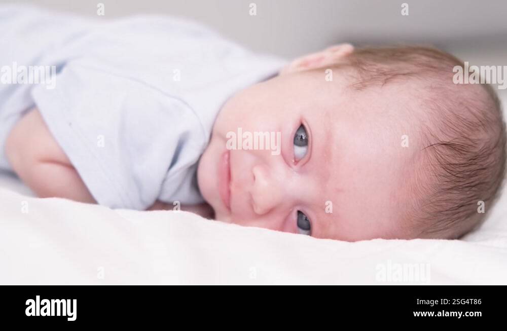 Dissatisfied, crying, upset, sad Newborn baby boy lying in nursery ...