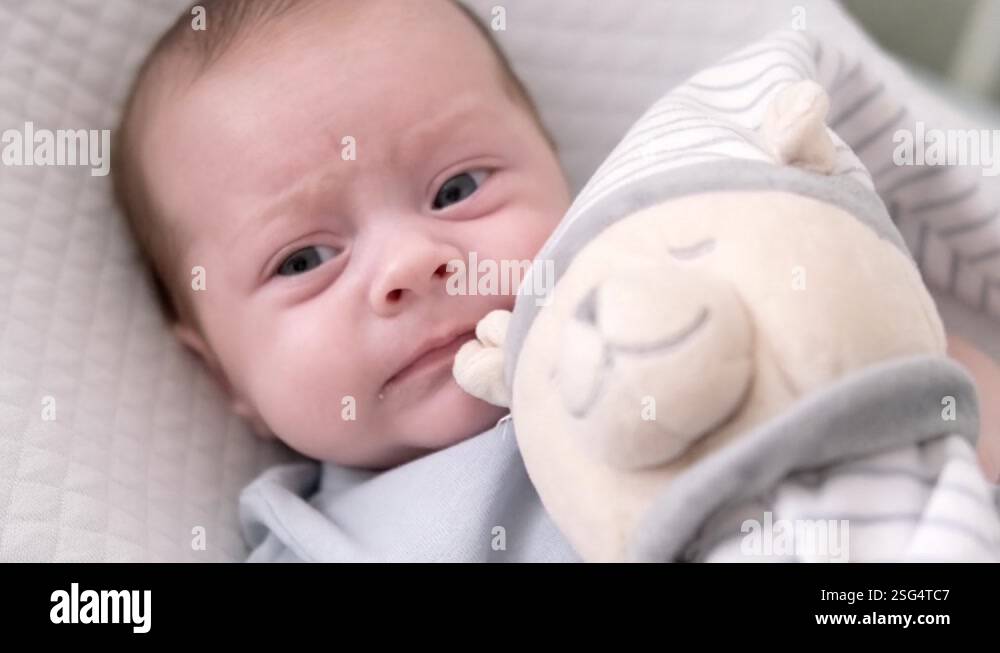 Dissatisfied, crying, upset, sad Newborn baby boy lying in nursery ...