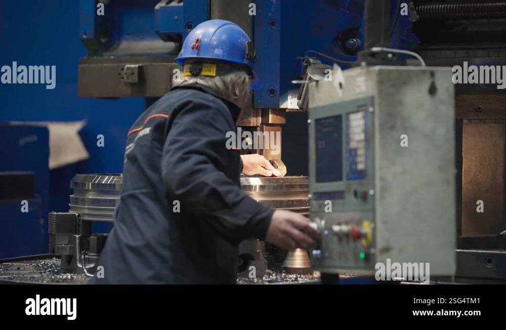 Maintenance engineer checks the performance of the industrial machine ...