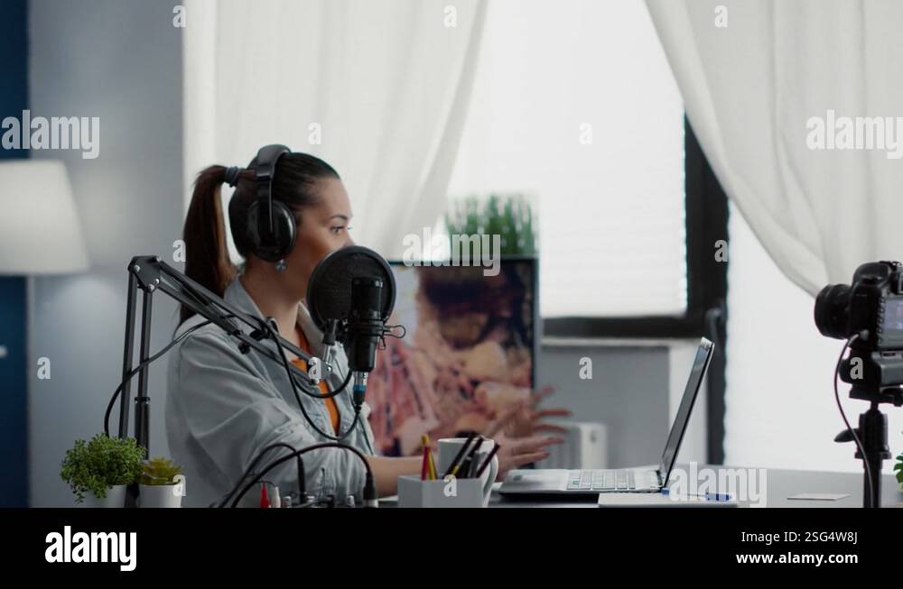 Internet live radio show host typing on computer while talking to ...