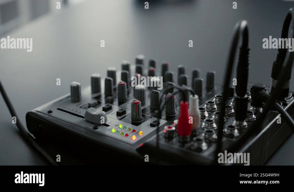 DJ mixer console with knobs and equalizer standing on home studio desk ...