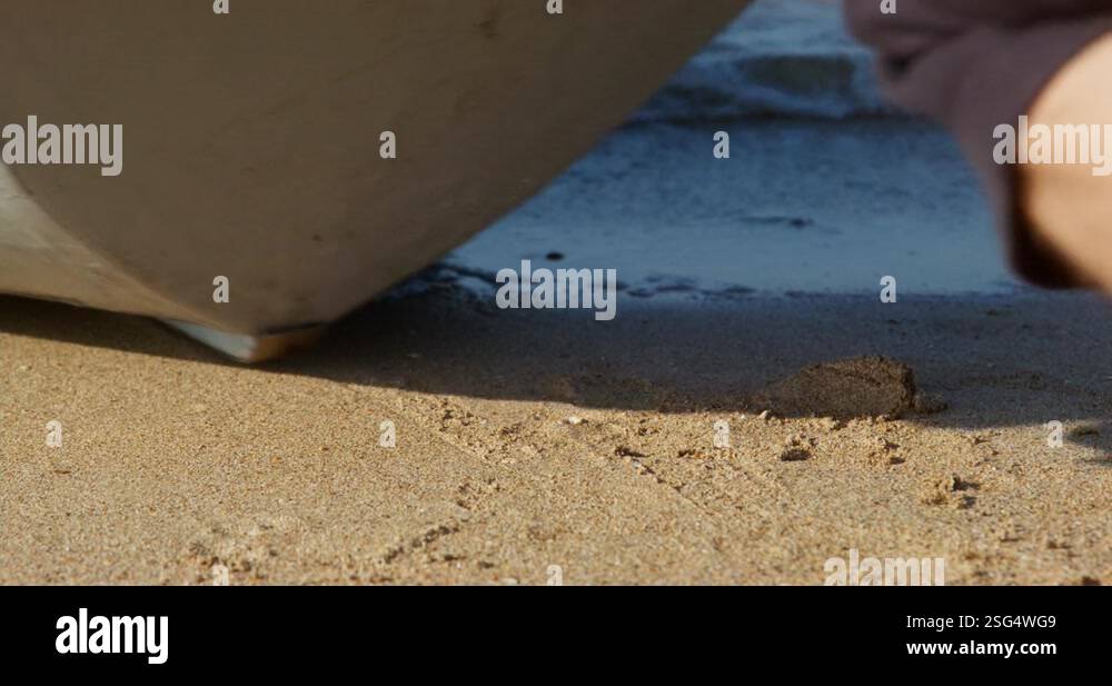 Bottom of ship on water. Downshifting. Man launches an old boat into ...