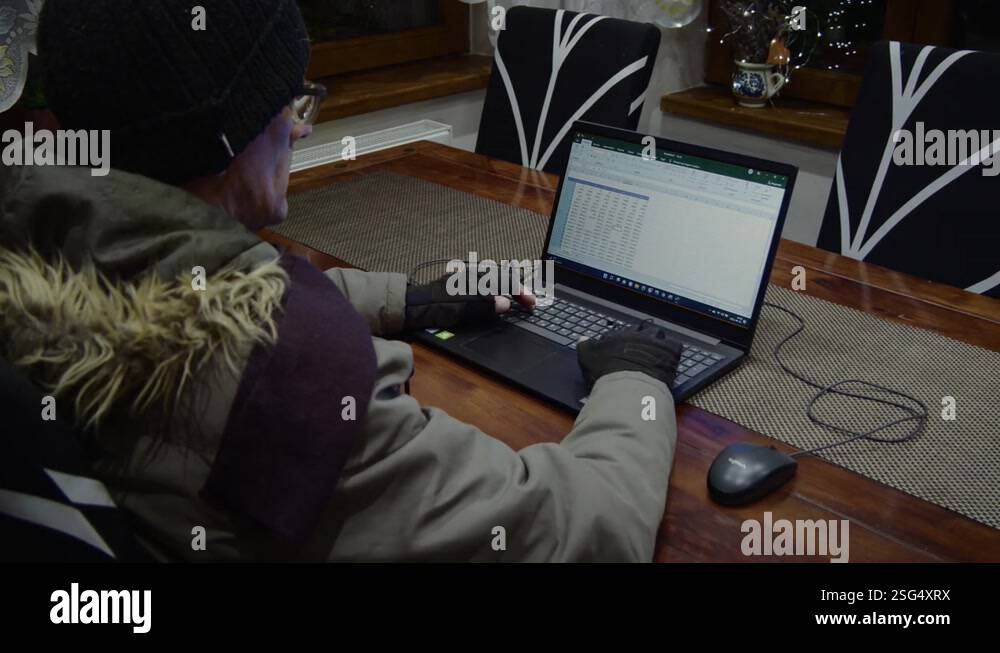 The man is working on a laptop in the unheated room. She was dressed in ...