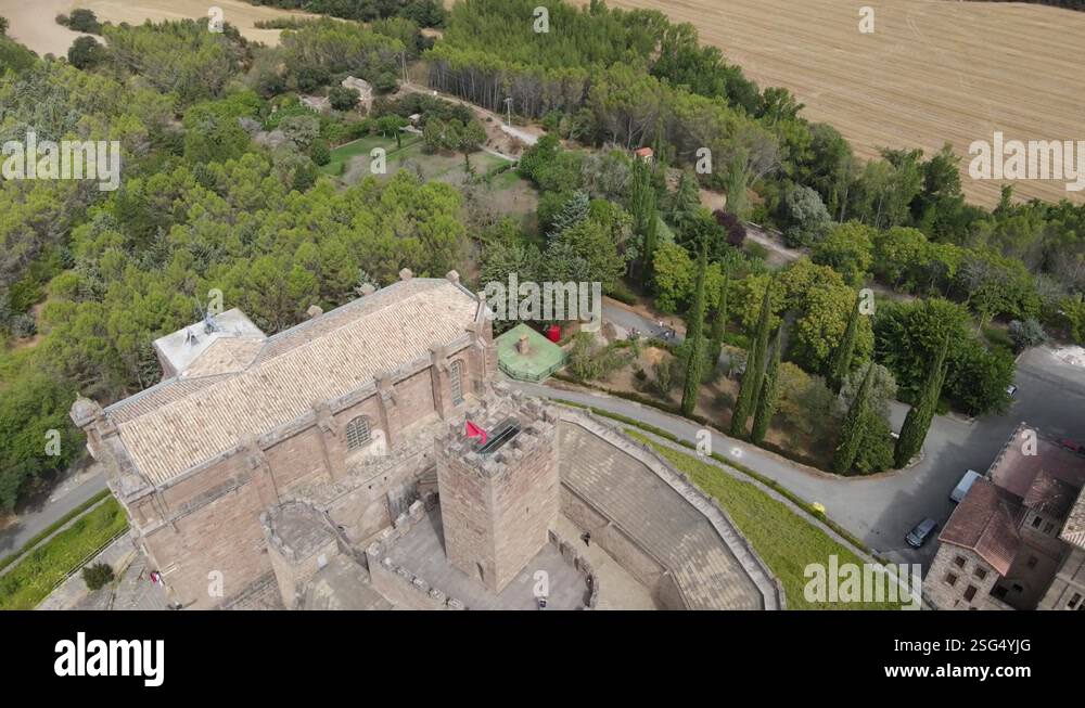 Inspiring medieval castle and basilica nestled in farmland, high angle ...