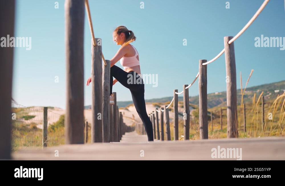 Flexible caucasian girl stretches legs after an intensive running ...