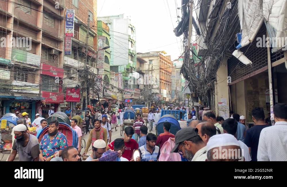 crowded streets of Dhaka filled with rickshaw traffic and pedestrians ...
