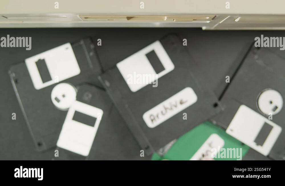 Using diskette close-up. Old floppy disk, disc drive top view. Retro ...