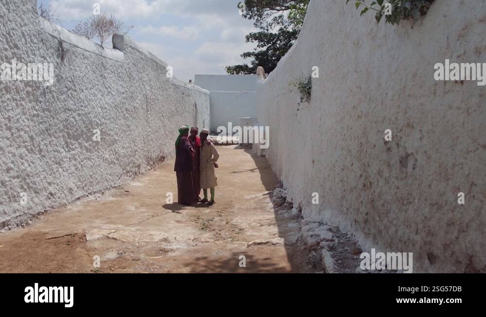Men at the entry of a muslim holy site, Harari Region, Harar, Ethiopia ...
