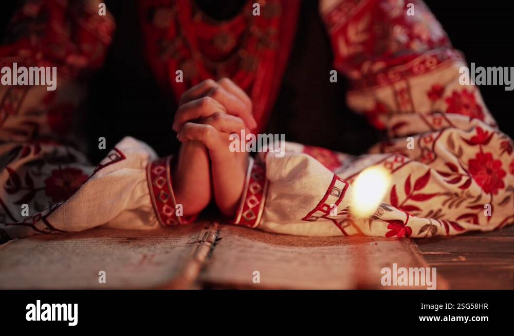 Ukrainian woman reading old book - Holy Bible and praying. Lady in traditional Stock Video ...