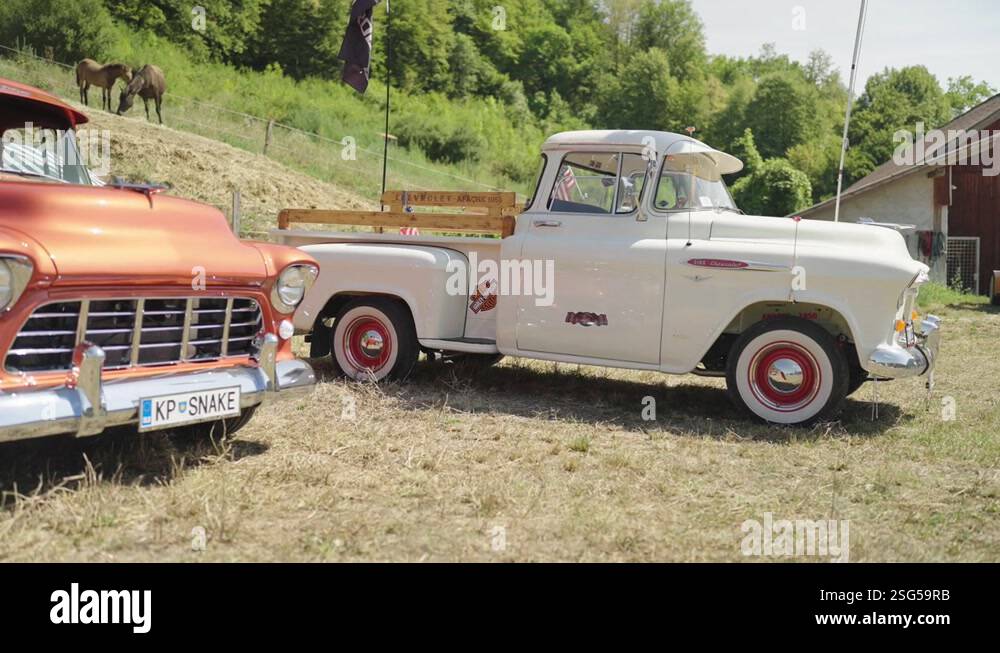 Two restored retro Chevrolet pickup trucks parked side by side in ...