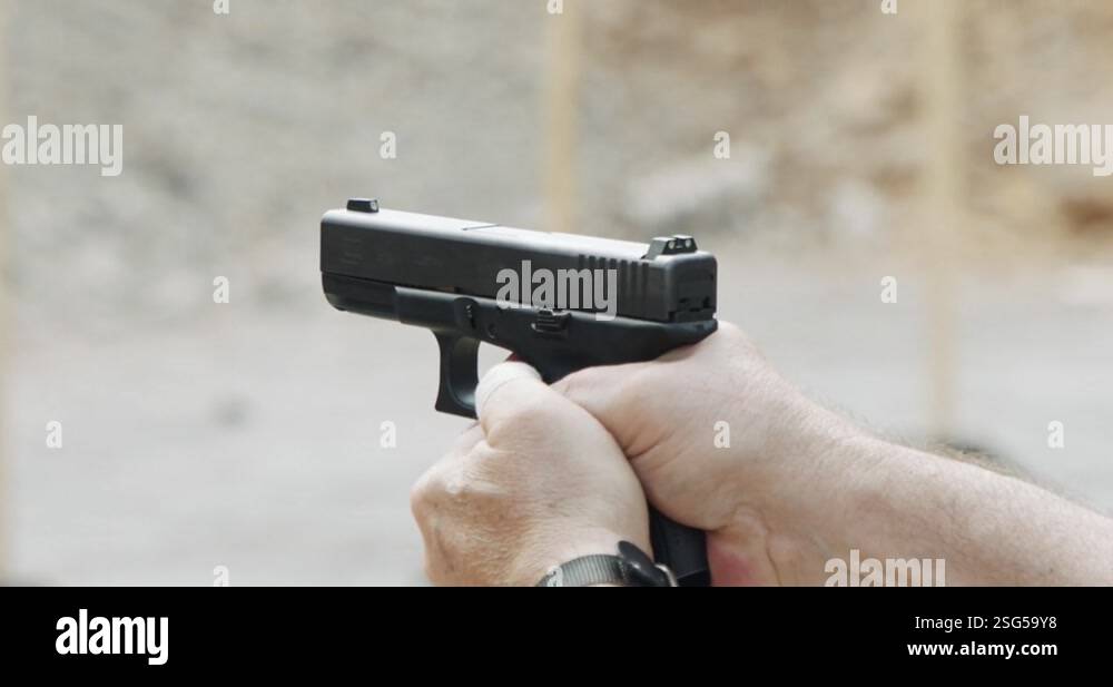 Pistol shooting bullets in slow motion footage. Hand guns in firing ...