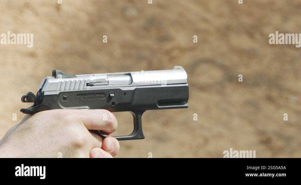 Close Up Footage Of A Hand Gun Firing In A Firing Range With Cartridge