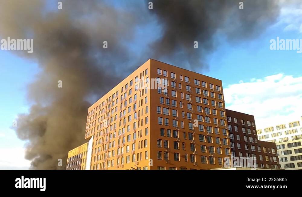 A fire in a multi-storey building, the building is burning, black smoke ...